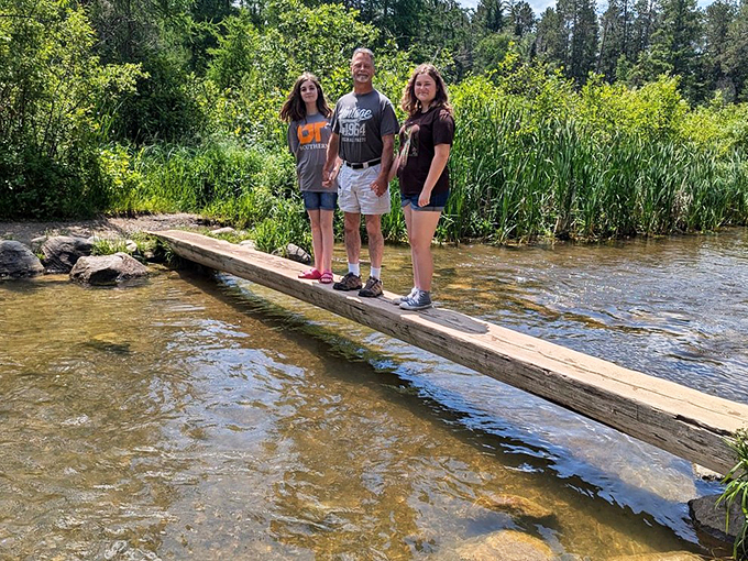 "Look, Ma, I'm walking on water!" Visitors channel their inner Jesus on a narrow log bridge, testing both balance and bravery.