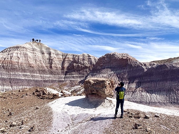 Tiny humans, big landscape! These intrepid explorers are getting their "Lawrence of Arabia" moment, minus the camels and plus some comfy hiking shoes.