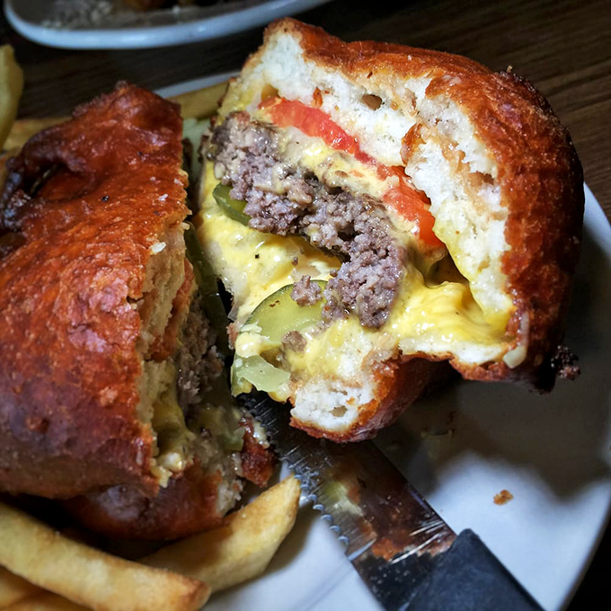 Behold the "Triple Bypass" burger! Three deep-fried patties stacked higher than my cholesterol. It's not a meal, it's a dare.