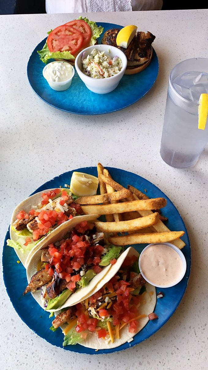 The holy trinity of beach eats: tacos, fries, and slaw. It's like someone bottled up summer and served it on a blue plate.