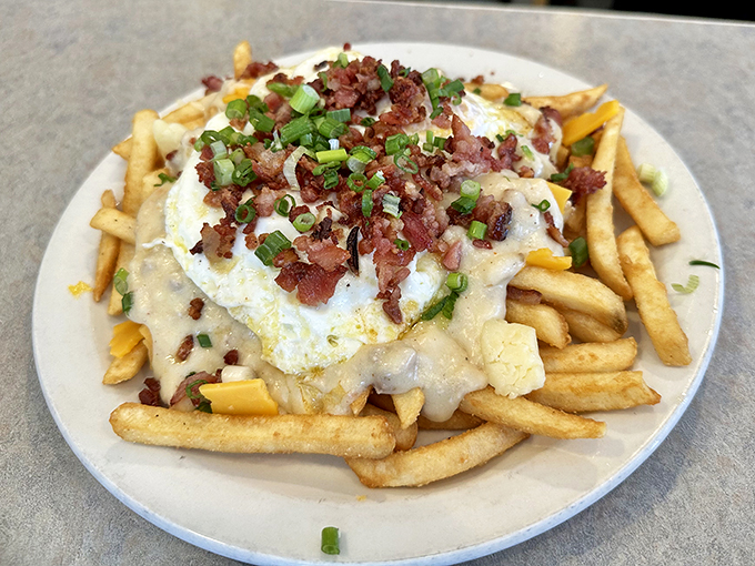 Fries, gravy, and enough toppings to make a salad bar jealous. This loaded poutine is the comfort food hug you didn't know you needed.