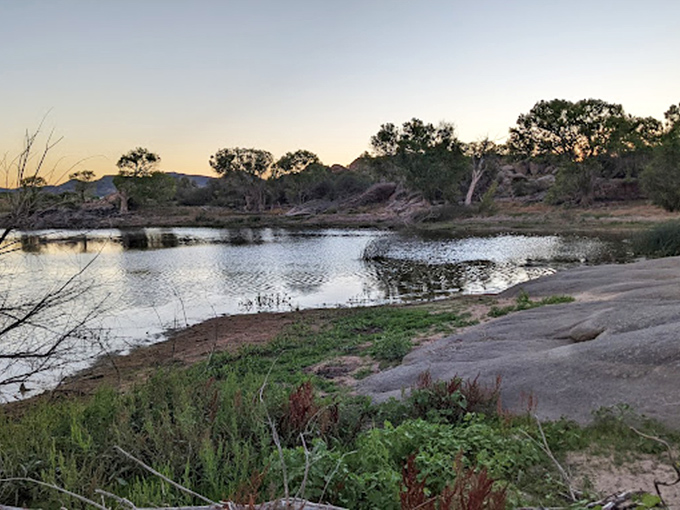 Golden hour goals! The lake transforms into nature's mirror, reflecting a sky that'd make Bob Ross proud.