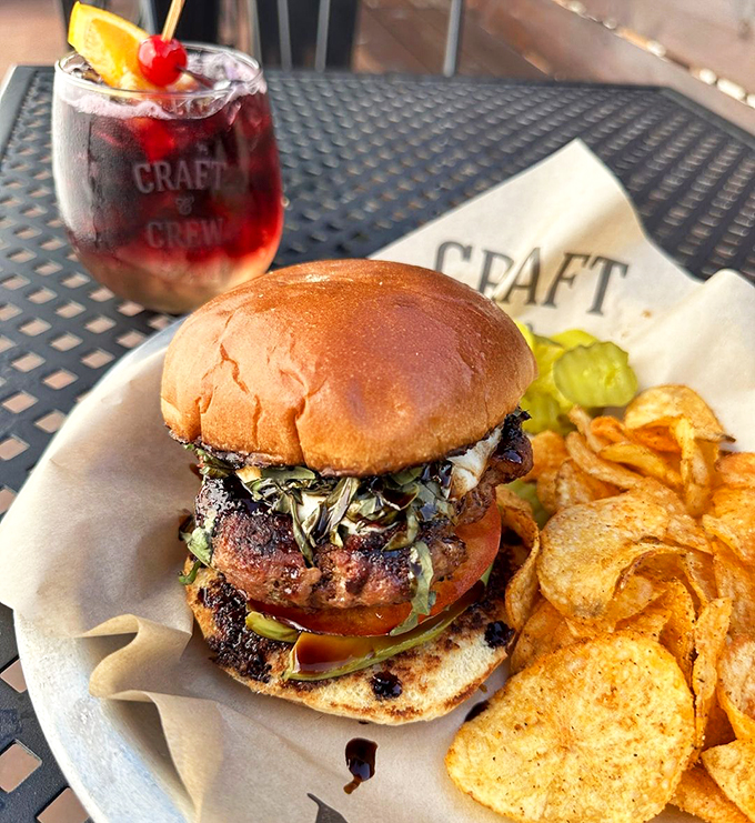 Holy cow, what a burger! This bad boy is stacked higher than my retirement dreams, with all the fixings a flavor junkie could want.