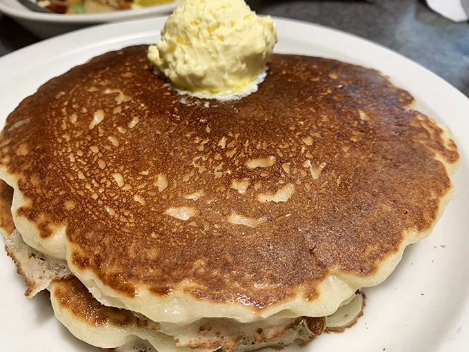 Pancakes so fluffy, they might float away if not for that generous pat of butter. Syrup application is a sacred ritual here.