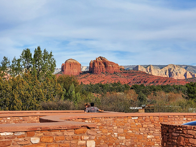 "I'm on top of the world, Ma!" Visitors soak in the view from a stone balcony, proving sometimes the best seats in the house are outside.