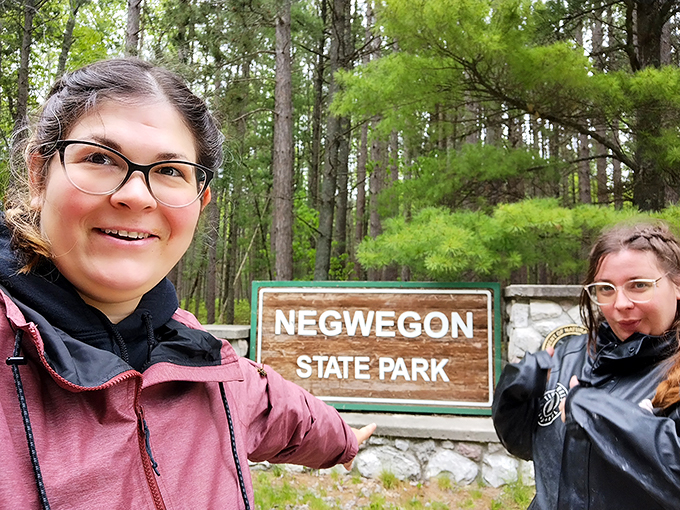 Adventurers unite at the gates of Negwegon! These happy campers look ready to tackle trails or simply bask in nature's glory.