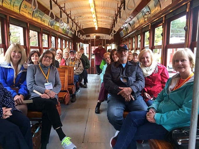 All smiles on the trolley express! These folks look like they've stumbled upon the world's most entertaining history lesson on wheels.