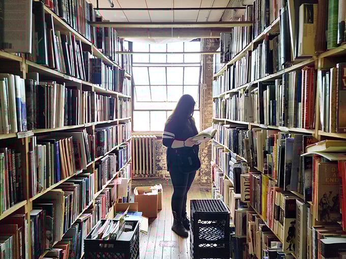 Caught in the act of literary love! A reader finds her perfect match amidst the towering shelves of possibility.