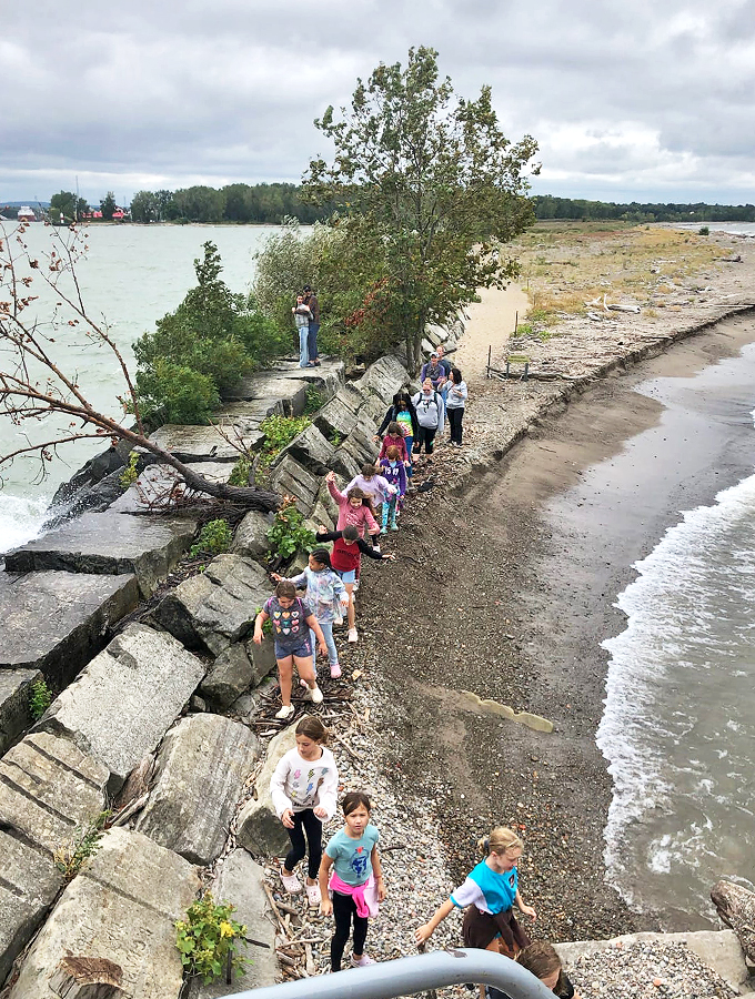 "Follow the leader! These intrepid explorers are braving the breakwater like a maritime version of 'The Amazing Race.'"