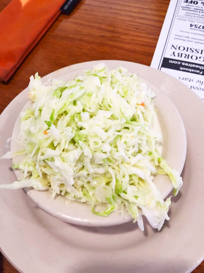 Meatloaf that mama would approve! Nestled next to a cloud of mashed potatoes, this hearty slice is comfort on a plate. It's like a warm hug for your taste buds.