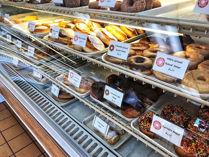 A rainbow of sweetness awaits! This donut display is like a edible color wheel, each hue promising a unique flavor adventure.