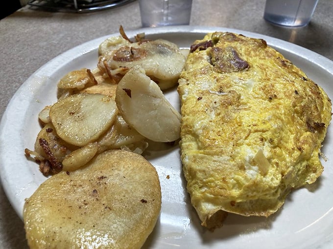 Eggs-cellent choice! This omelet, packed with goodies and flanked by crispy potatoes, is the breakfast of champions &ndash; and regular folks who just love good grub.