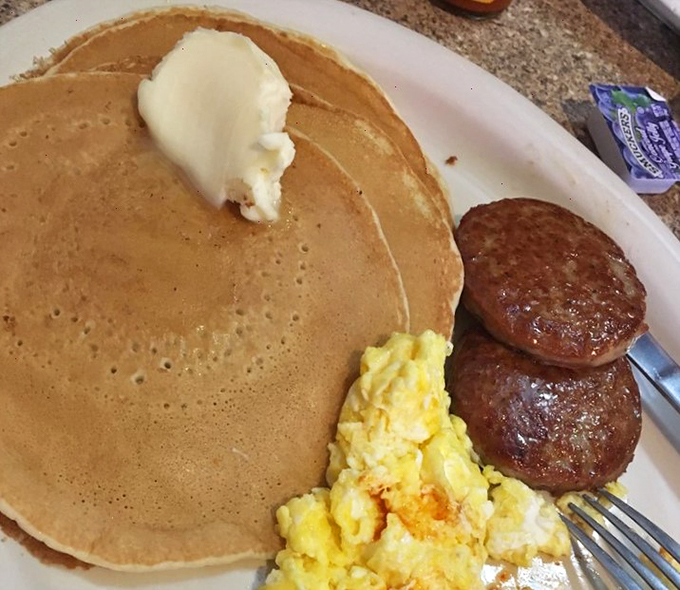 Pancakes so fluffy, they could double as pillows. With a dollop of butter melting like a warm hug, it's breakfast nirvana.
