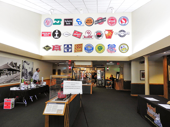 A kaleidoscope of railroad history adorns the walls, each logo a portal to a different era of American travel. It's like Instagram for train nerds, minus the filters.