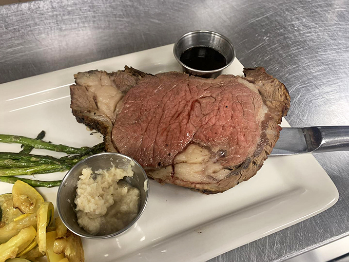 A plate that screams "treat yo' self!" Prime rib takes center stage, flanked by its trusty sidekicks: crisp asparagus and a baked potato that's basically a meal in itself.