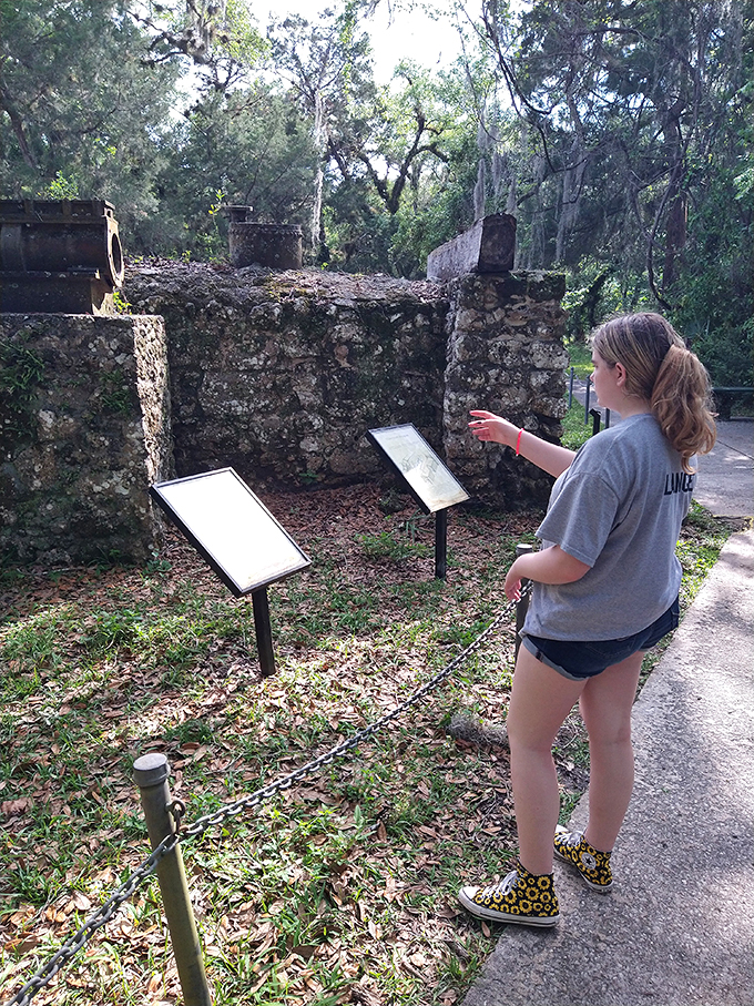 History comes alive through curious eyes. This young explorer drinks in centuries of stories, proving learning can be as sweet as candy.