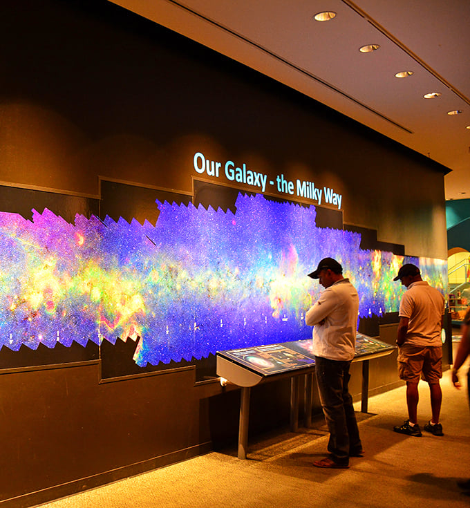 Cosmic cocktail hour? These visitors are drinking in the wonders of the universe, proving that sometimes, the best intoxication comes from knowledge.