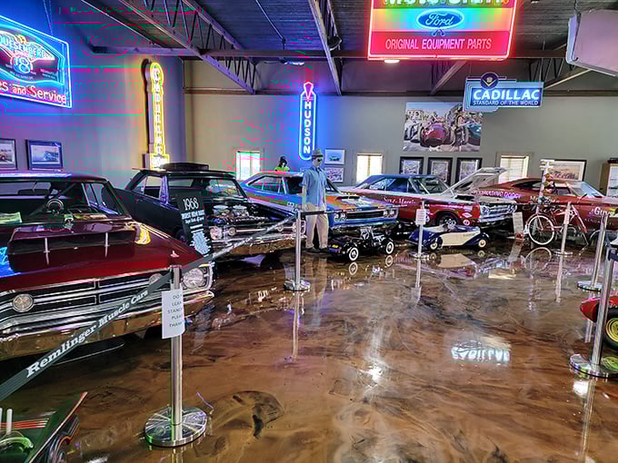 Neon signs cast a magical glow over chrome treasures – like stepping into an automotive disco where the cars are the real stars.