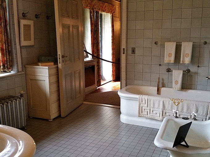 "Bathing like a Vanderbilt!" This pristine bathroom, with its gleaming tiles and monogrammed towels, proves that even early 20th-century hygiene could be haute couture.