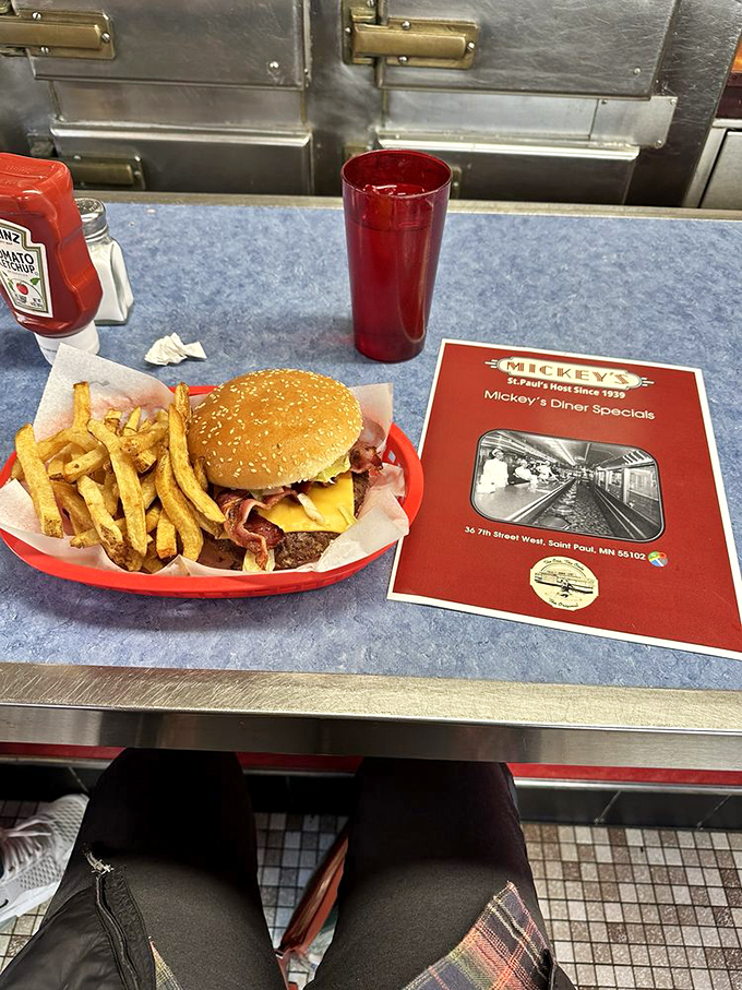 Hold onto your hats, folks! This burger's so tall, it needs its own zip code. Fries on the side? More like a delicious landing pad!