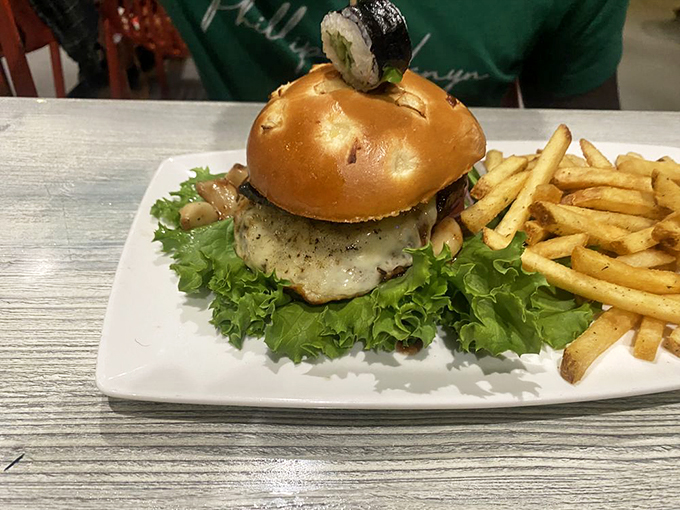 Burger lovers, rejoice! This juicy masterpiece comes with a side of crispy fries and a tiny sushi roll hat. Talk about having it all!