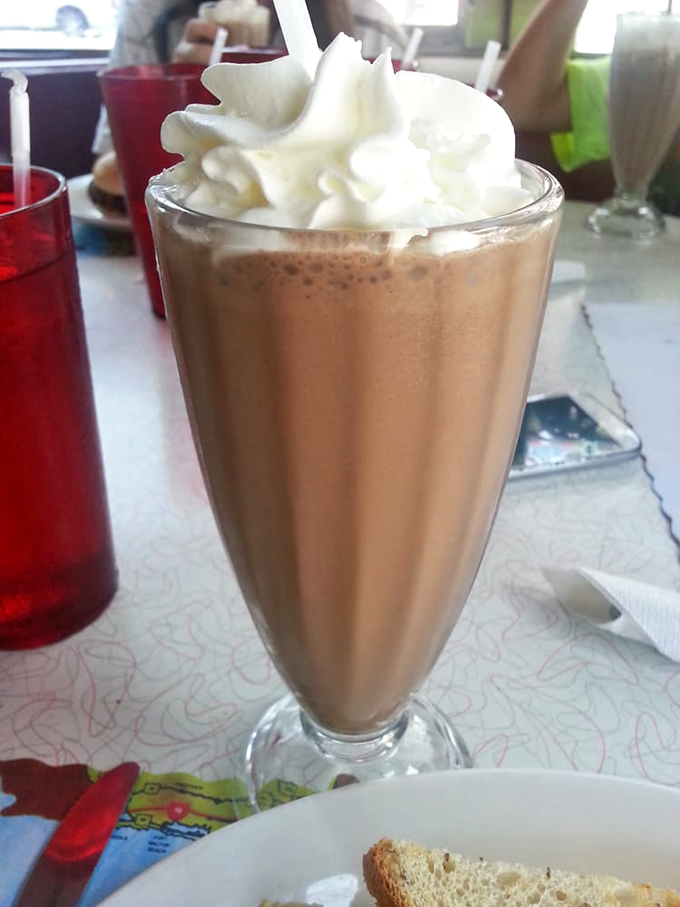 Holy moly, that's not a milkshake—it's a tower of creamy decadence! It's as if chocolate and peanut butter had a baby, and that baby was delicious.