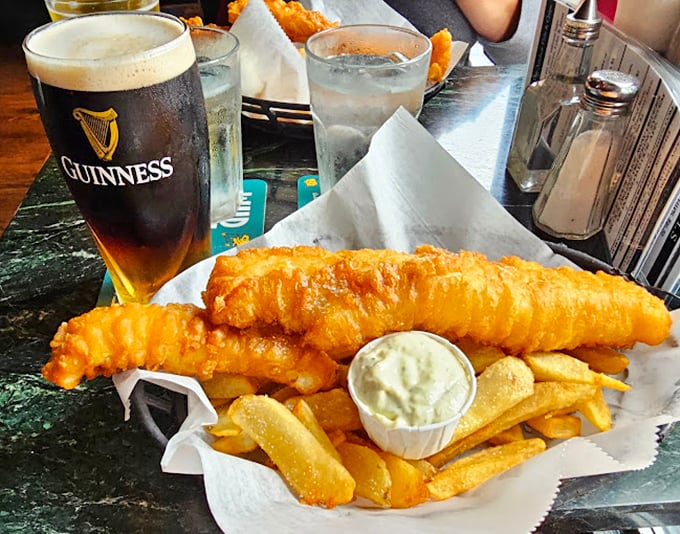 The holy trinity of pub grub: perfectly battered fish, crispy chips, and a pint of Guinness. It's practically a religious experience for your taste buds.