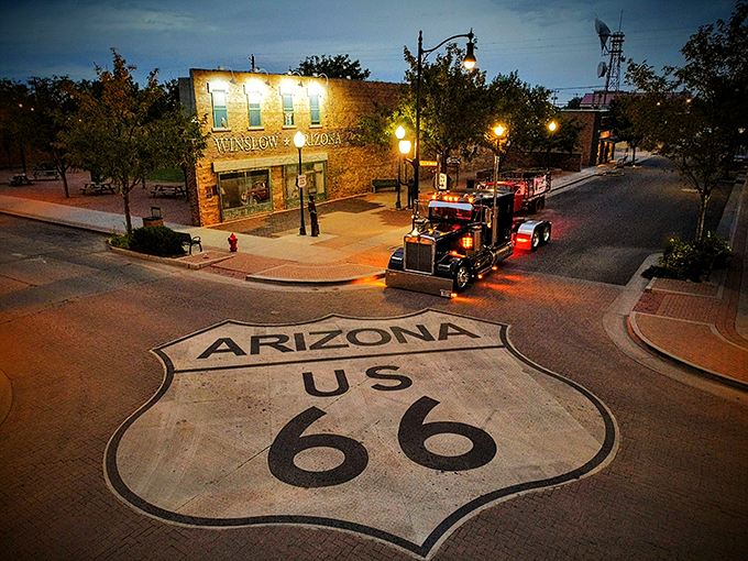 Night falls on Winslow, but the corner never sleeps. The neon glow and rumbling trucks create a nocturnal symphony that would make Don Henley proud.