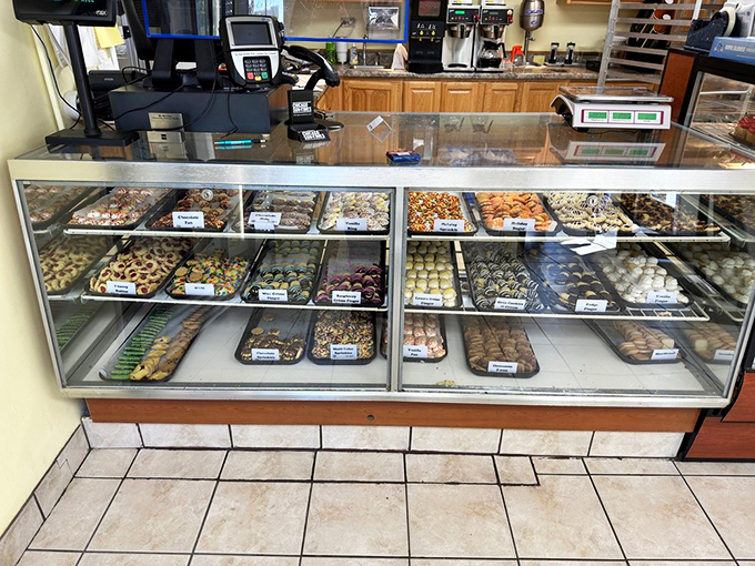 Pastry perfection on parade! This display case is a United Nations of baked goods, where every treat is vying for your attention.