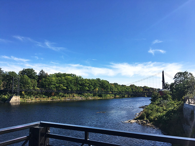 Nature's grand stage: The Kennebec River flows on, indifferent to the drama of human history playing out above its waters.