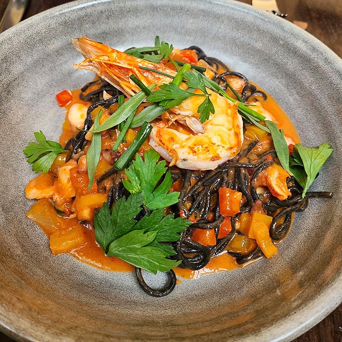 Spaghetti nero: where squid ink meets pasta in a dance of flavors. It's like the Little Black Dress of the pasta world &ndash; eternally chic and always satisfying.