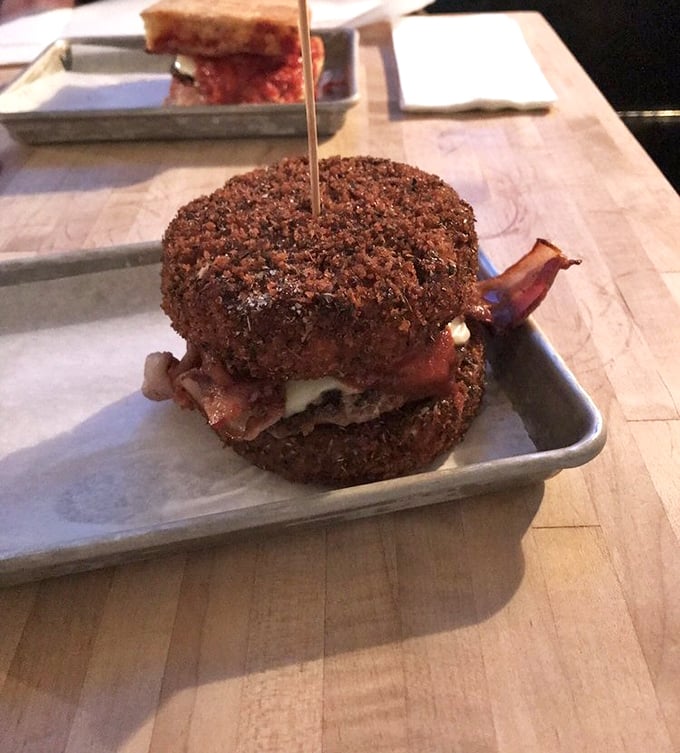 Brace yourself for a flavor explosion! This crispy, cheesy behemoth is what happens when a burger and mac & cheese have a delicious love child.