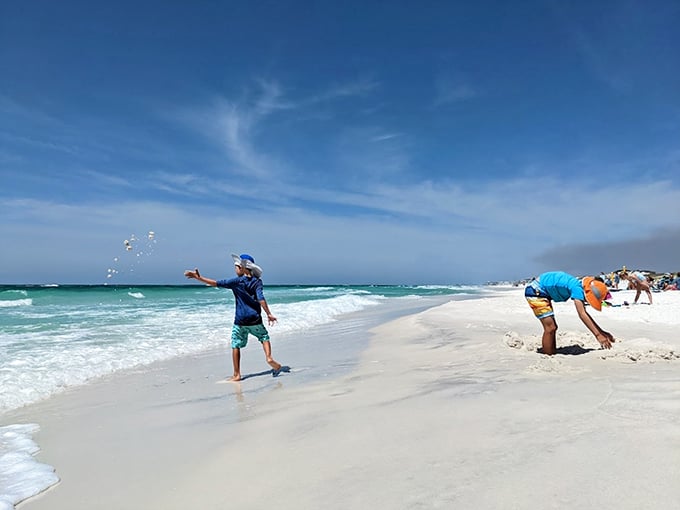 Sandy shenanigans: Kids prove that the best beach toys are free. Who needs sandcastles when you can be a human sprinkler?