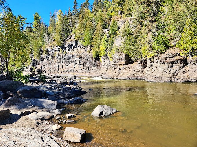 Nature's own rock concert! The river carves its way through ancient stone, creating a symphony of rushing water and timeless beauty.