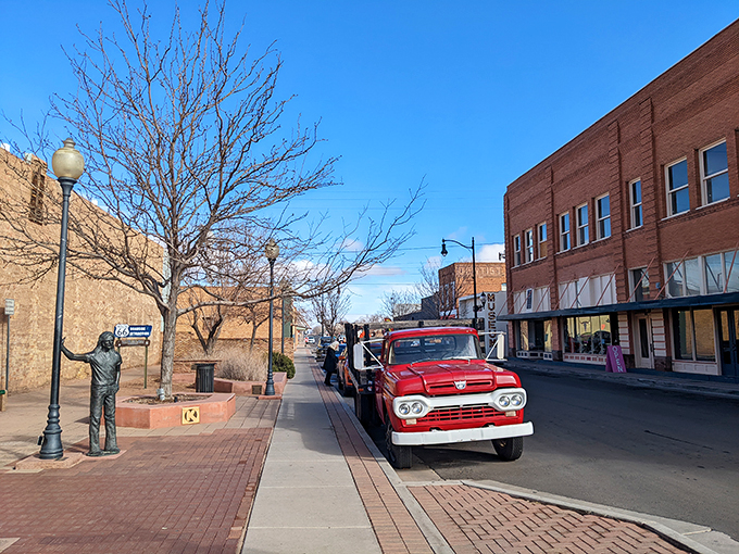 A red flatbed Ford and a statue create the perfect Eagles-inspired tableau. It's like someone hit pause on a music video from the '70s.