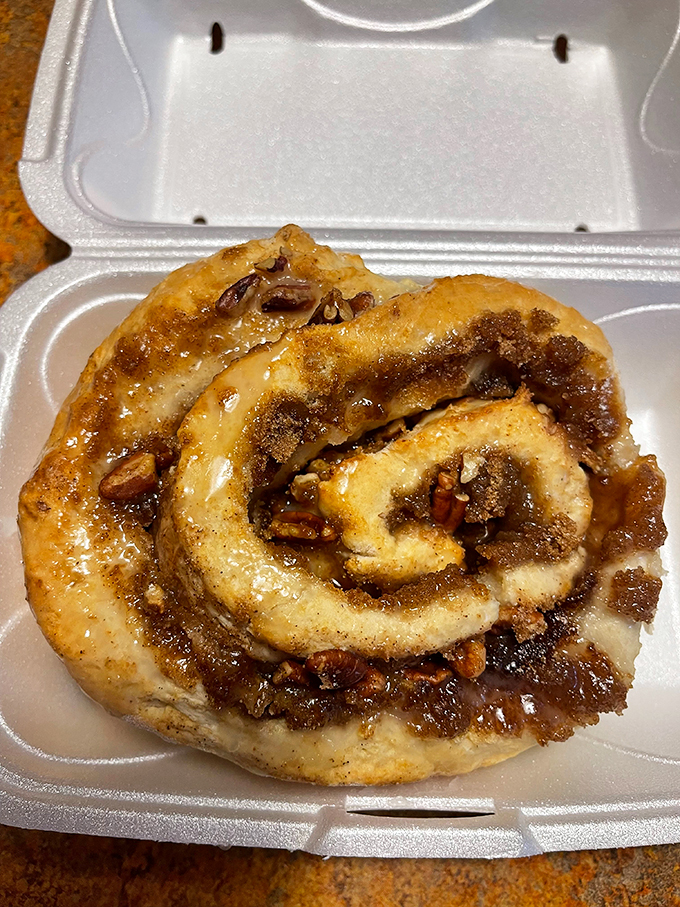 Warning: This cinnamon roll may cause involuntary drooling. It's not just breakfast; it's a religious experience with a side of pecans.
