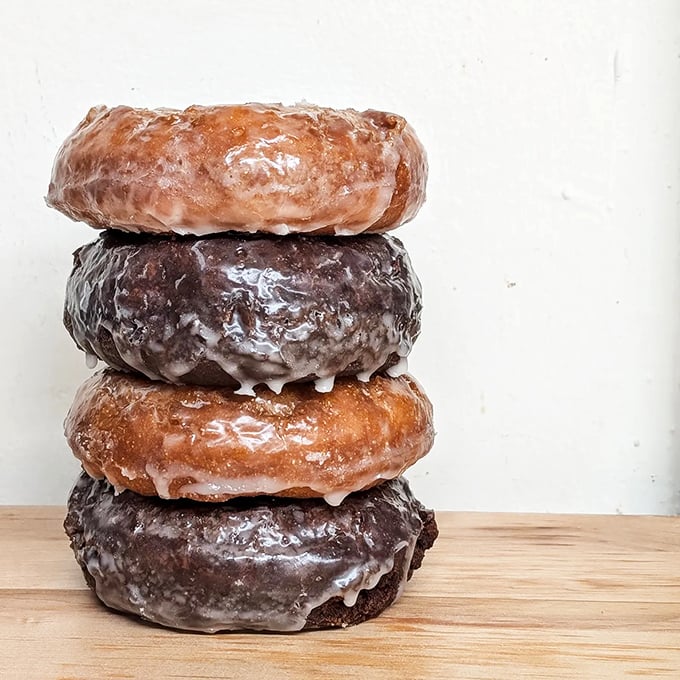 Classic glazed donuts lined up like soldiers of sweetness, each one ready to make someone's morning better.