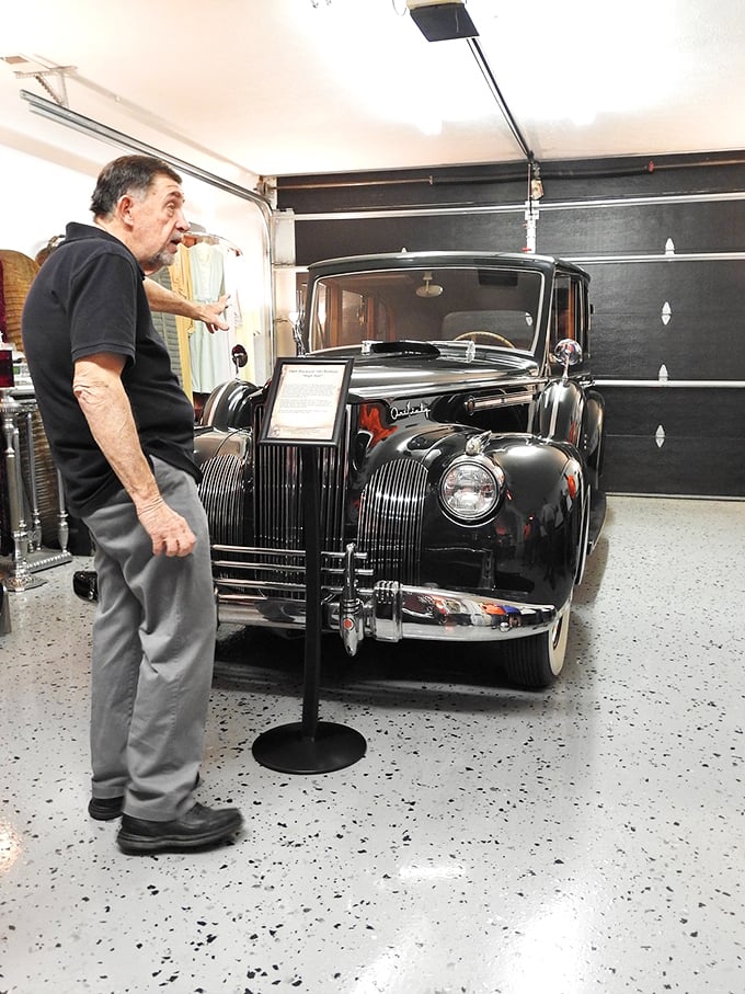 "And over here, we have our latest model..." This knowledgeable guide brings history to life as he showcases a classic piece of funeral transportation.