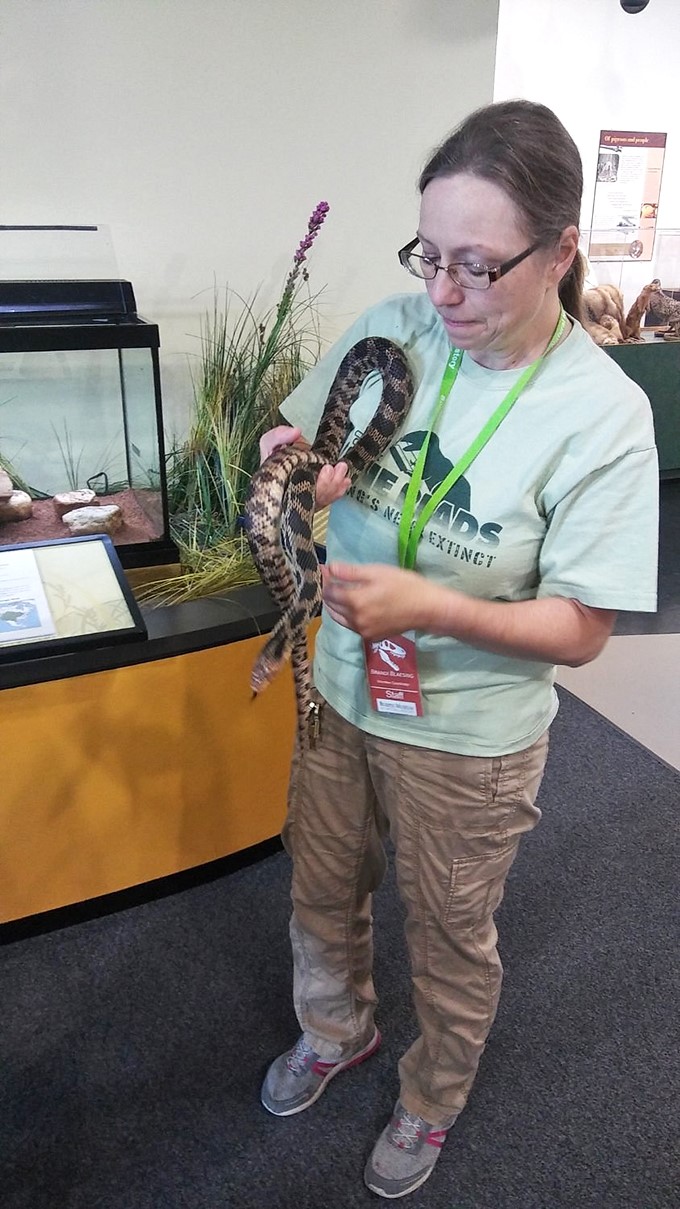 Snake charmer or museum magician? This staff member's got nerves of steel and a passion for scales.