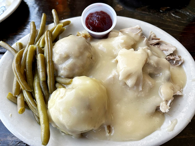 This isn't just a meal; it's a turkey-pocalypse on a plate. Biscuits, cranberry sauce, and enough gravy to swim in &ndash; challenge accepted!