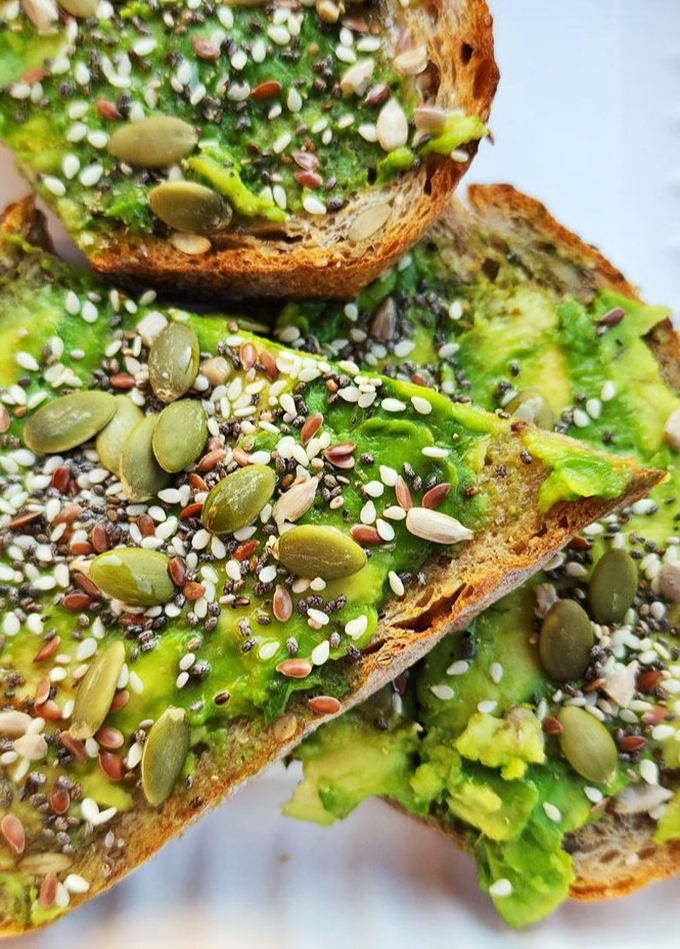 Avocado toast that's more extra than your favorite reality TV star. Seeds and greens galore – it's a garden party on bread!