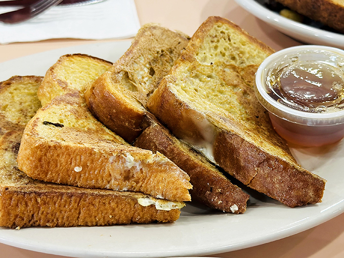 Golden slices of heaven! This French toast looks like it's been sunbathing on a beach of powdered sugar. 