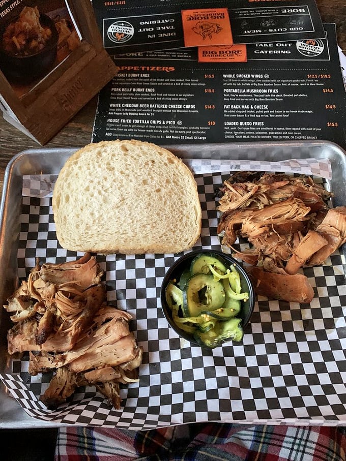 Pulled pork perfection! This sandwich is piled high with tender, juicy meat that's been loved by smoke and time. It's comfort food at its finest.