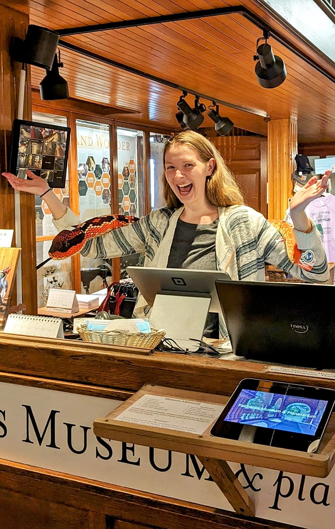 Enthusiasm's the name of the game! This staff member's smile is brighter than the museum's lighting – and just as illuminating.