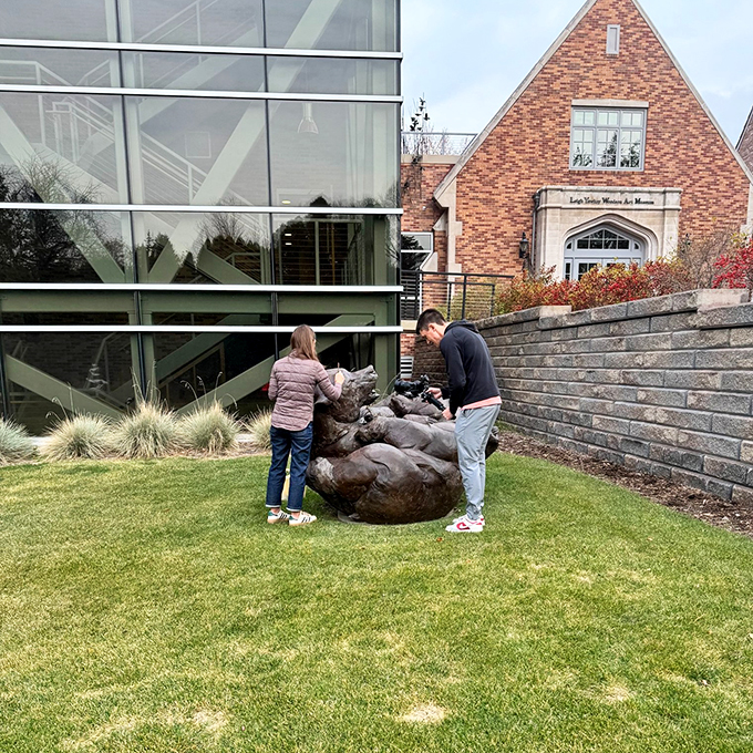 Hands-on art appreciation! These visitors are getting to grips with a playful sculpture, showing that sometimes art is meant to be touched, not just seen.