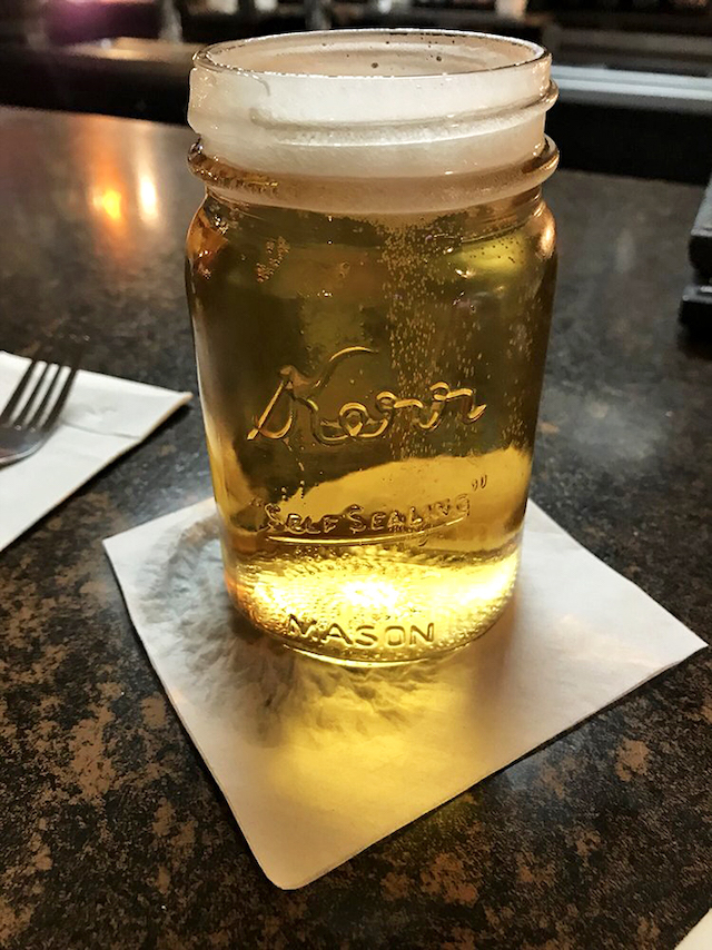 Cheers to local flavor! This golden brew in a Mason jar isn't just a drink, it's a Midwest handshake in liquid form.