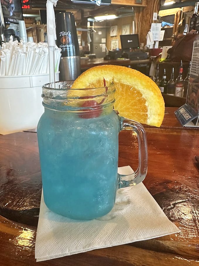 Is it a drink or a portal to a tropical paradise? This Duval Teal cocktail is serving serious vacation vibes in a mason jar.