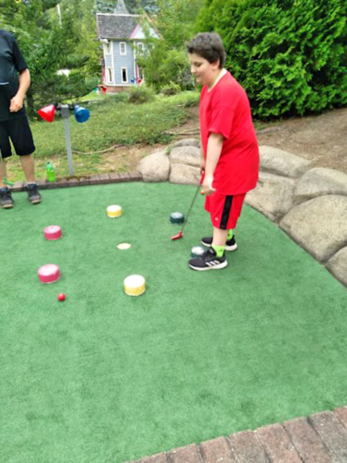 Hole in one or hole in none? This young golfer contemplates life's big questions on the mini-green. Phil Mickelson, watch your back!