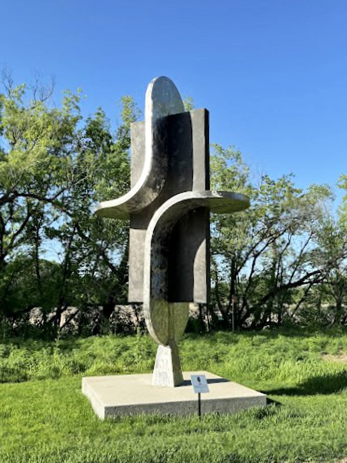 Abstract art or futuristic coat rack? This intriguing sculpture adds a touch of modern flair to the traditional garden setting.