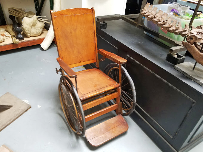 This vintage wheelchair isn't just for sitting pretty. It's a time machine on wheels, ready to roll you back to the Victorian era.